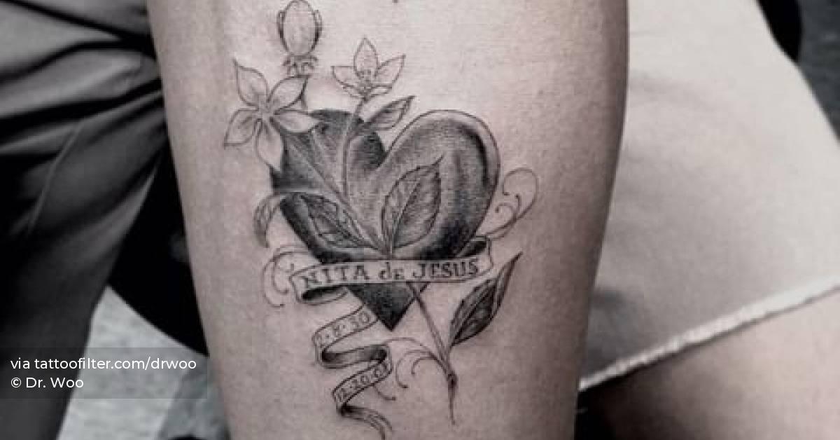 Heart and banner tattoo located on the inner forearm.