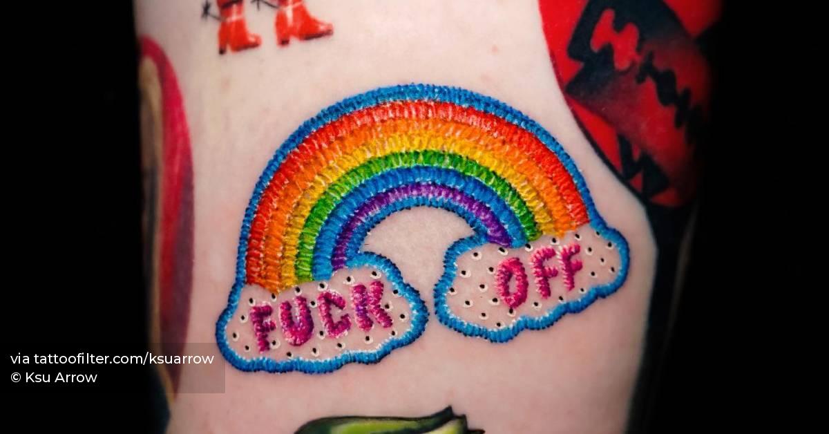 Rainbow patch with the words "fuck off" tattooed on the