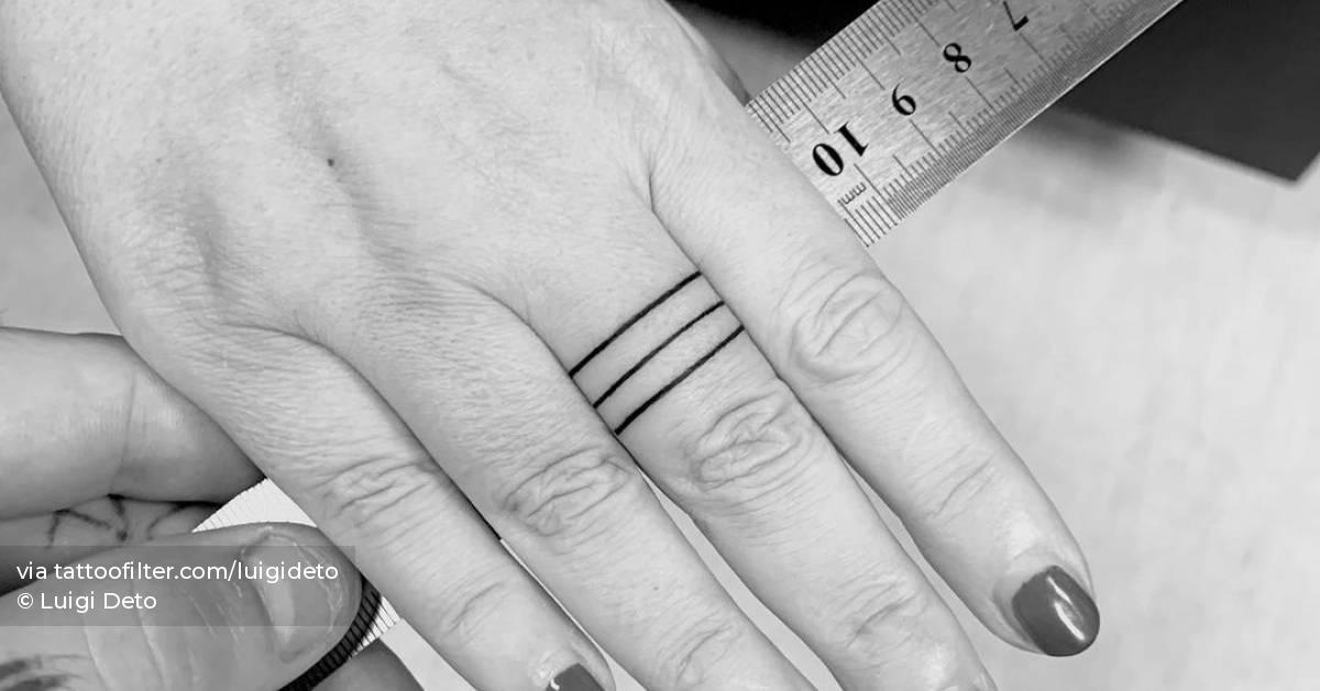 Minimalistic line art ring tattoo located on the