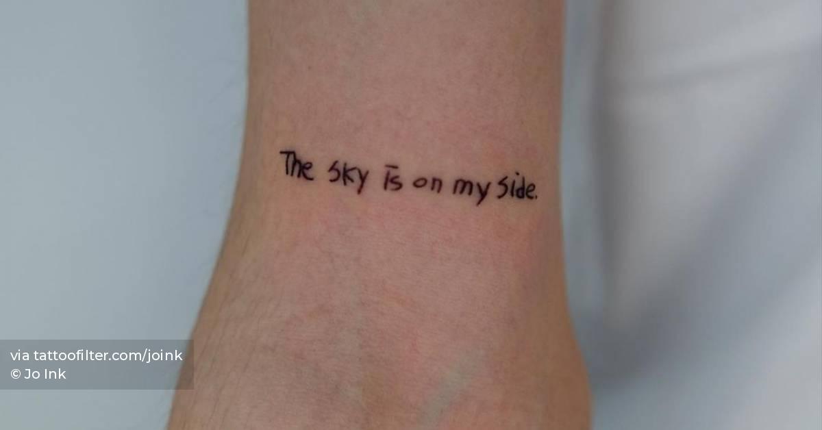 "The sky is on my side" lettering tattoo located on the