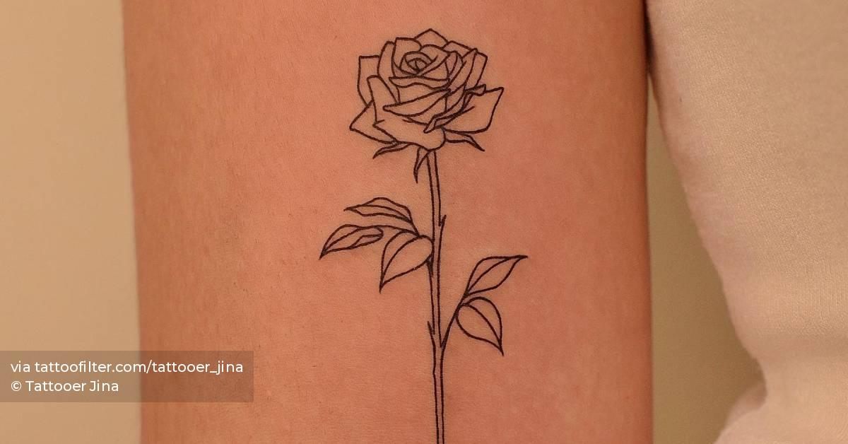 Fine line rose tattoo located on the inner arm.