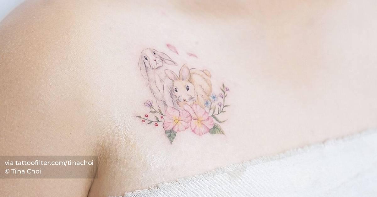 Watercolor rabbits tattoo on the chest.
