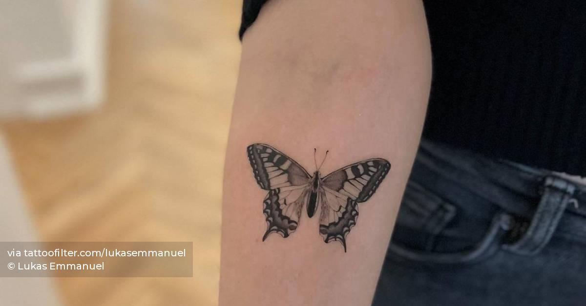 Micro-realistic butterfly tattoo located on the inner