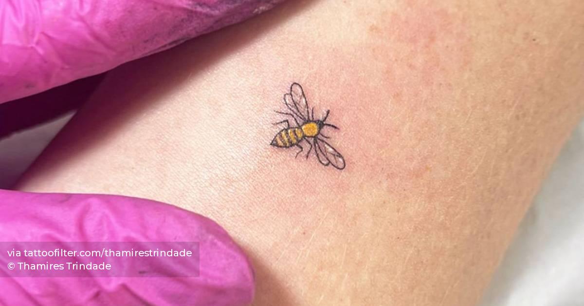 Tattoo of a little bee placed on the bicep.