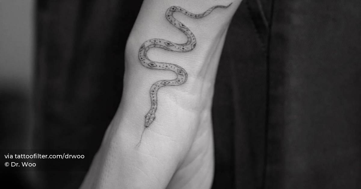 Single needle snake tattoo located on Georgie Flores'
