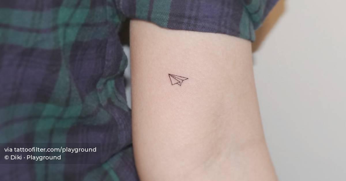 Tiny paper plane tattoo done on the wrist.