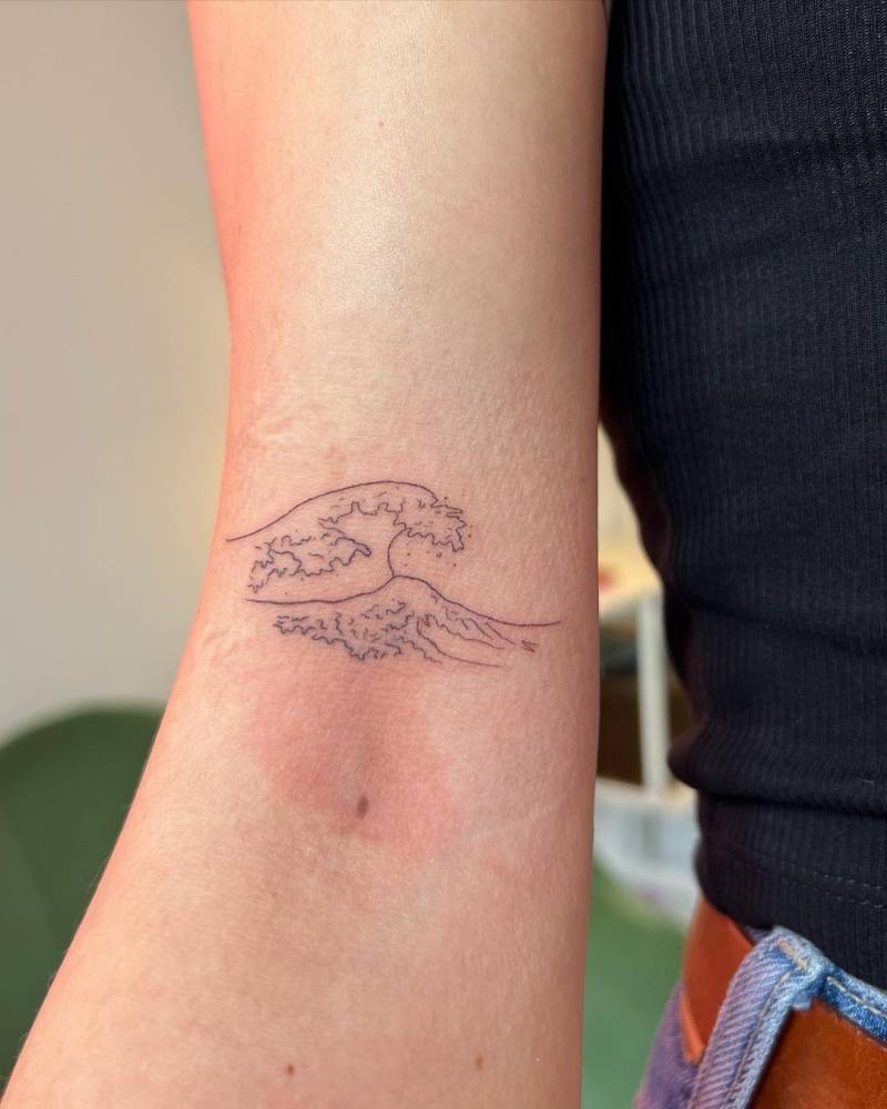 Fine Line Style Wave Tattoo Done On The Bicep Fine Line Style Wave Tattoo Done On The Bicep