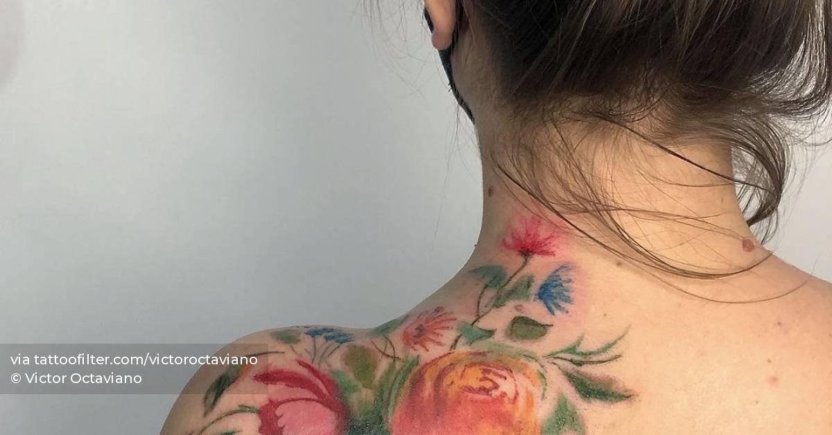 Watercolor style flowers tattoo located on the shoulder