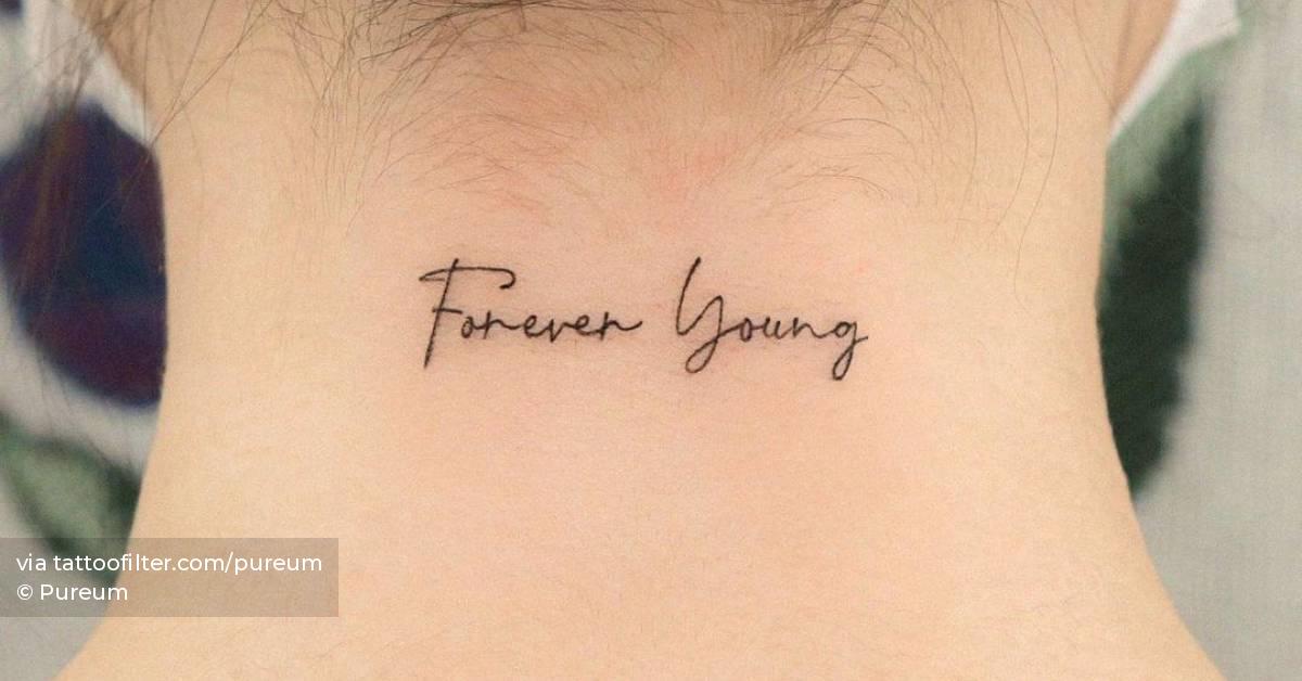 "Forever Young" lettering tattoo located on the back of