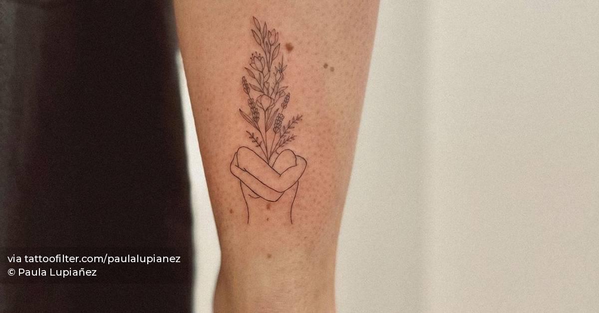 Fine line flower head woman tattoo placed on the