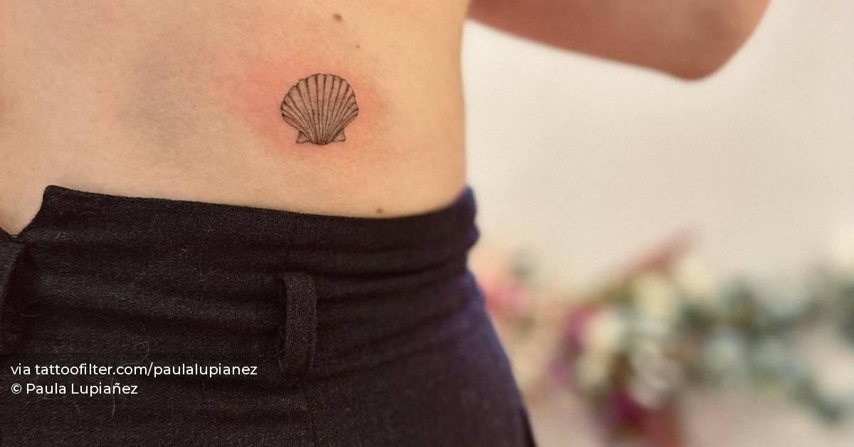 Little shell tattooed on the lower back.
