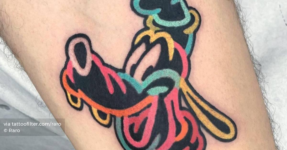 Neon Goofy portrait tattoo located on the thigh.