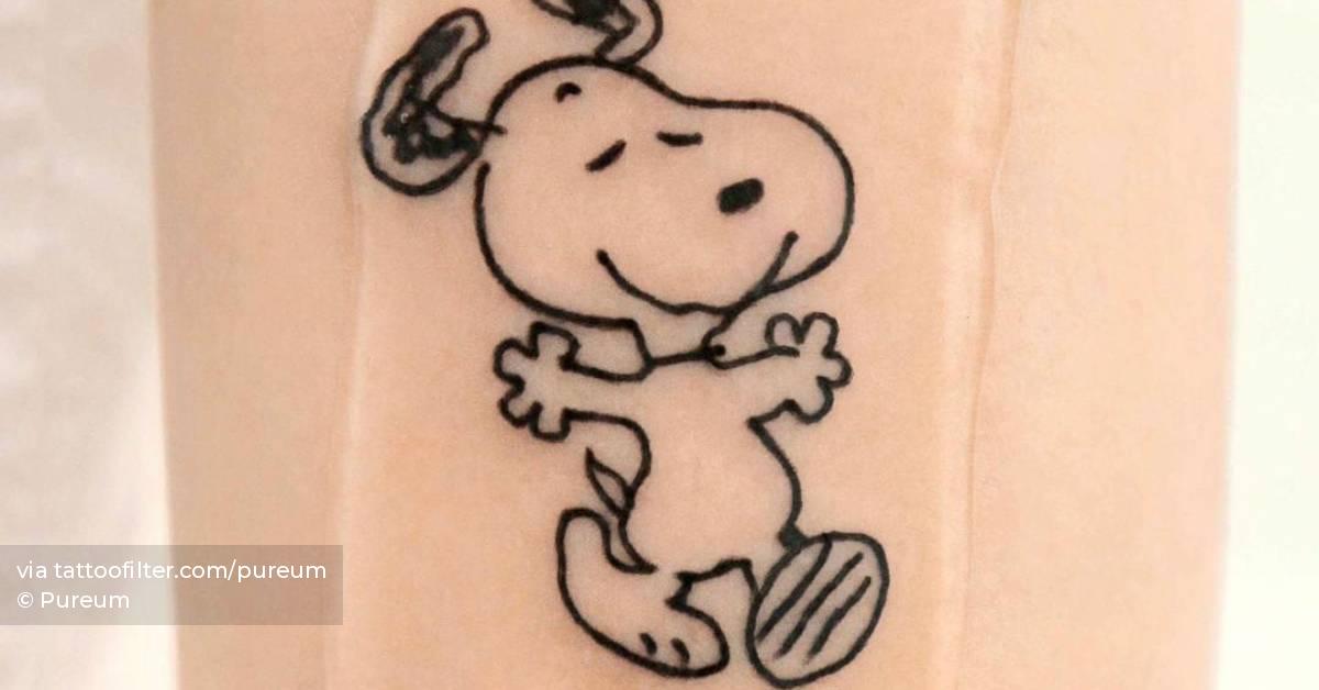 Snoopy tattoo done on the inner arm, cartoon style.