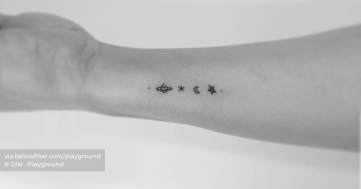 Minimalistic universe tattoo located on the wrist.