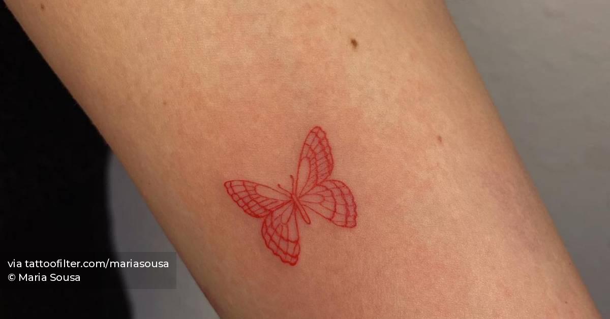 Fine line style red butterfly tattoo located on the