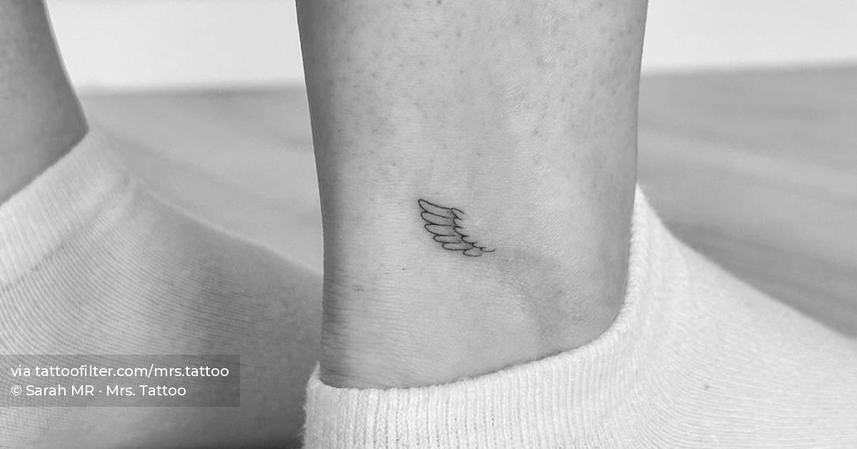Fine line minimalistic wing tattoo located on the