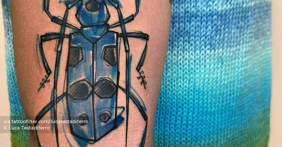 Sketch work style bug tattoo located on the upper arm.