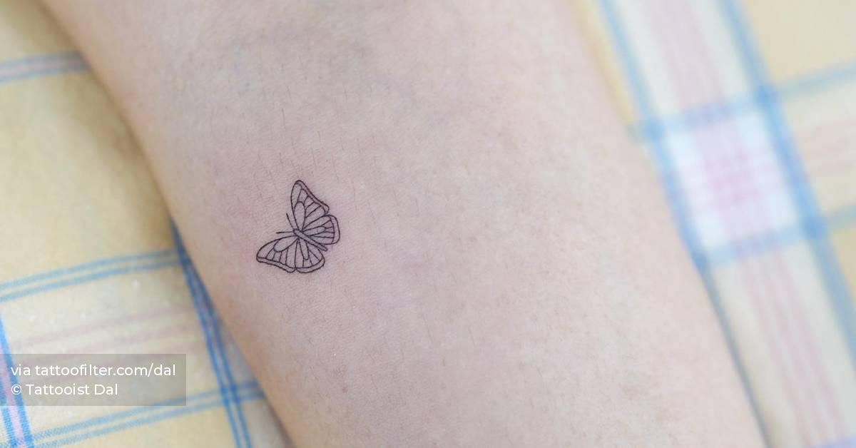 Fine line style butterfly tattooed on the inner