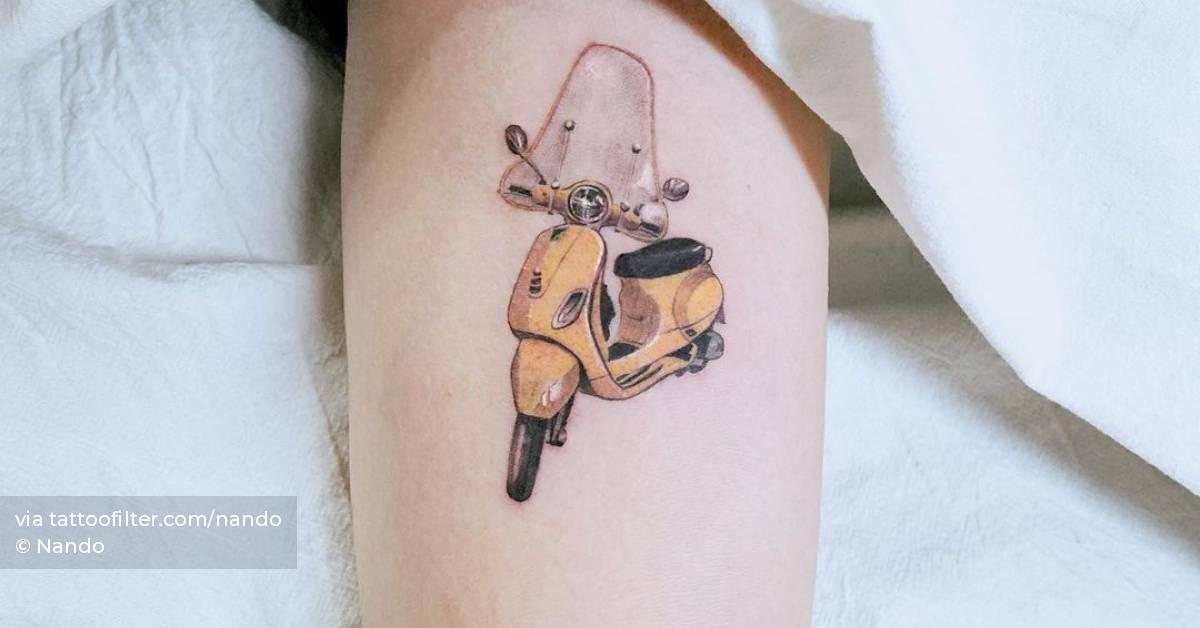 Micro-realistic Vespa tattoo on the upper arm