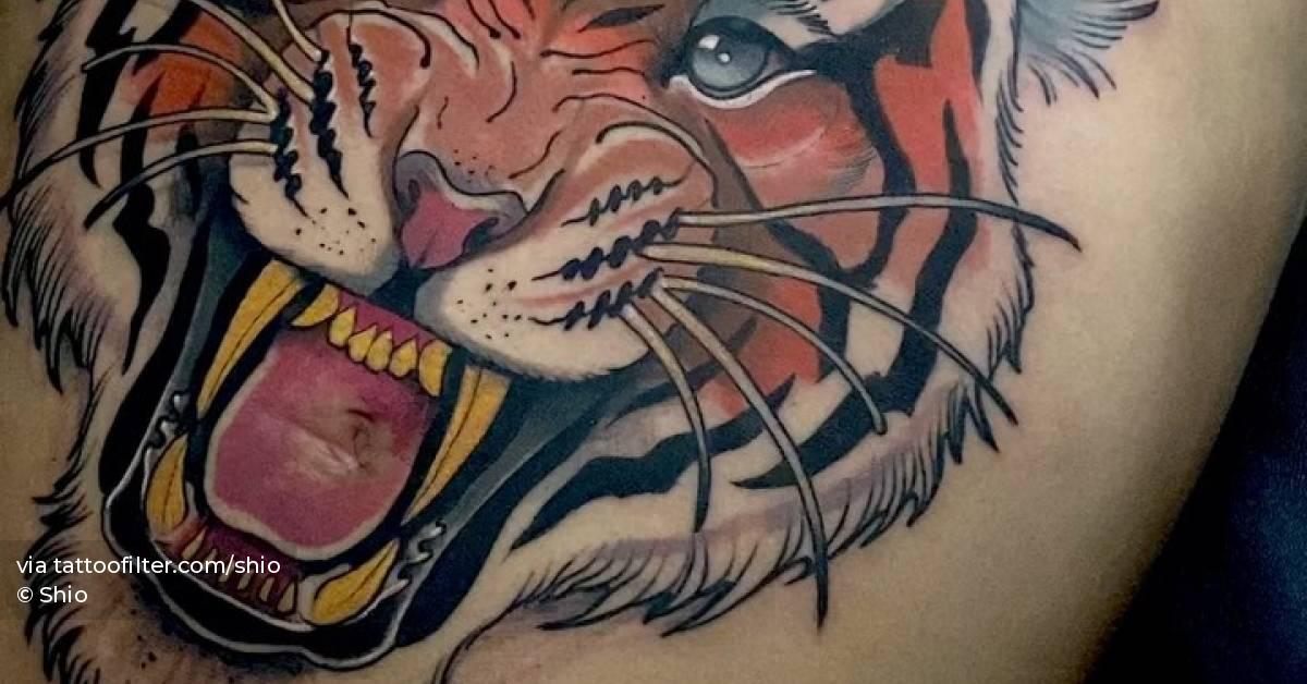 Huge tiger head tattoo located on the stomach,