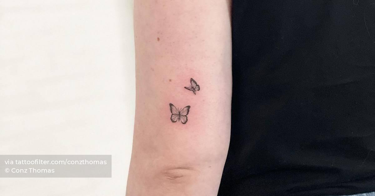 Fine line micro butterfly couple tattoo located on the