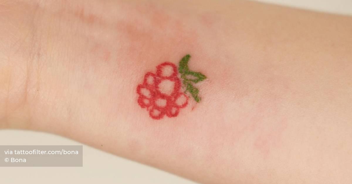 Minimalistic crayon effect raspberry tattoo located on