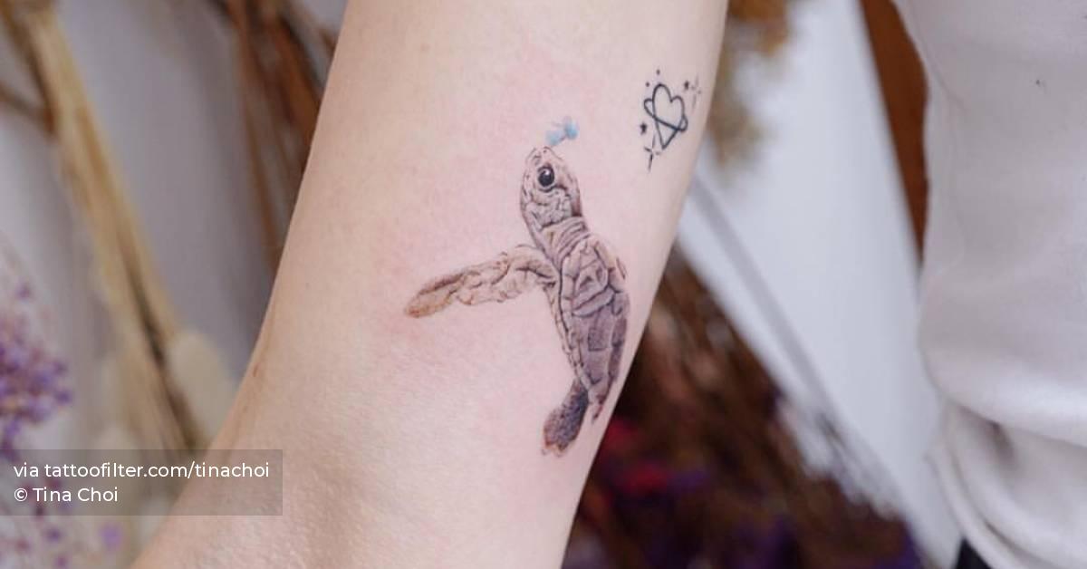 Micro-realistic turtle tattoo on the inner arm.