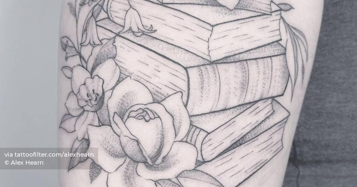 Fine line books and flowers tattoo on the upper arm.