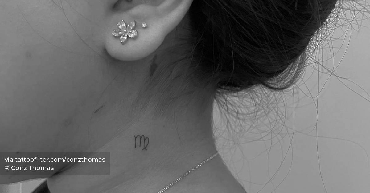 Tiny minimalistic virgo zodiac symbol tattooed on the