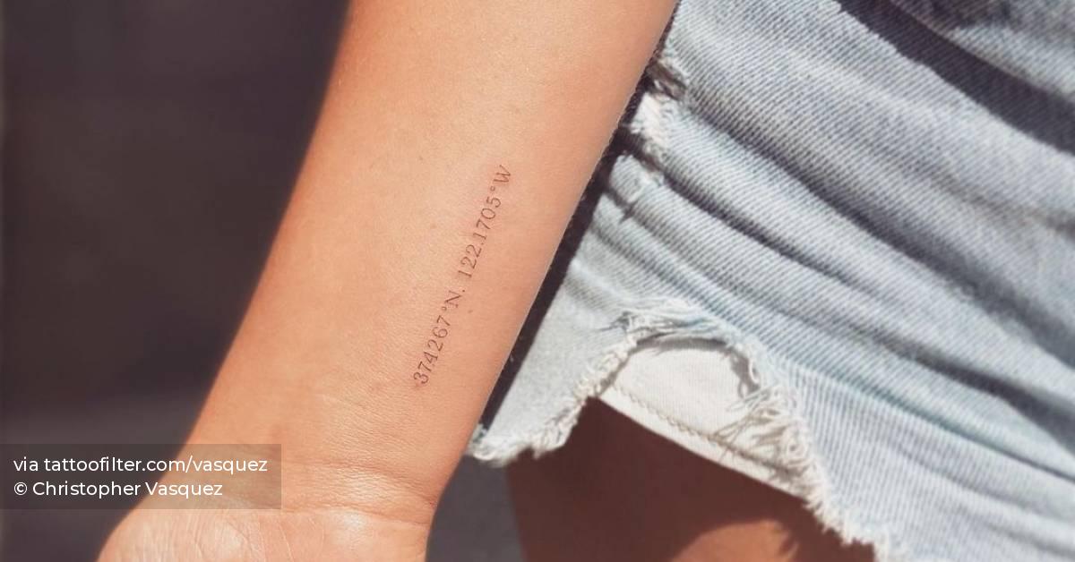 Coordinates lettering tattoo on the wrist.
