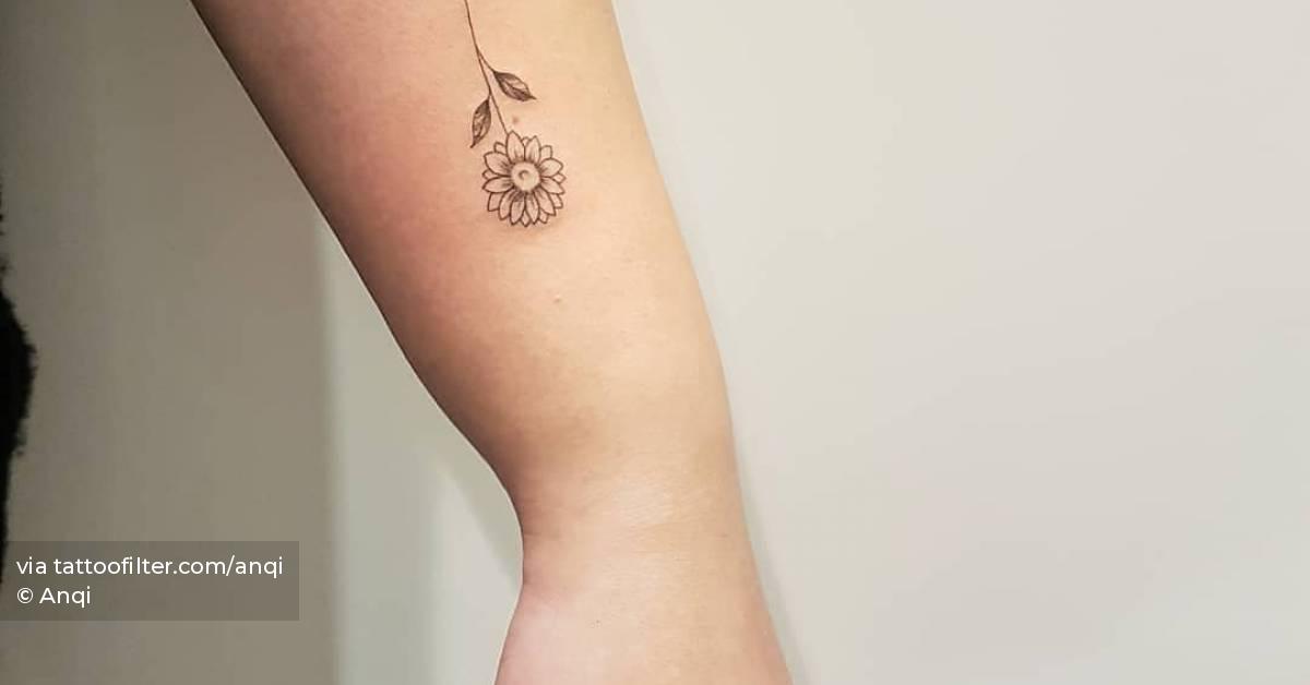 Fine line sunflower tattoo located on the wrist.