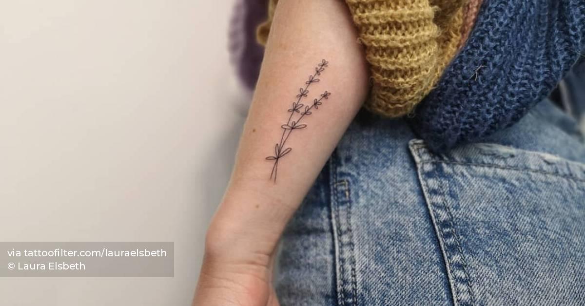 Fine line lavender tattoo located on the wrist.