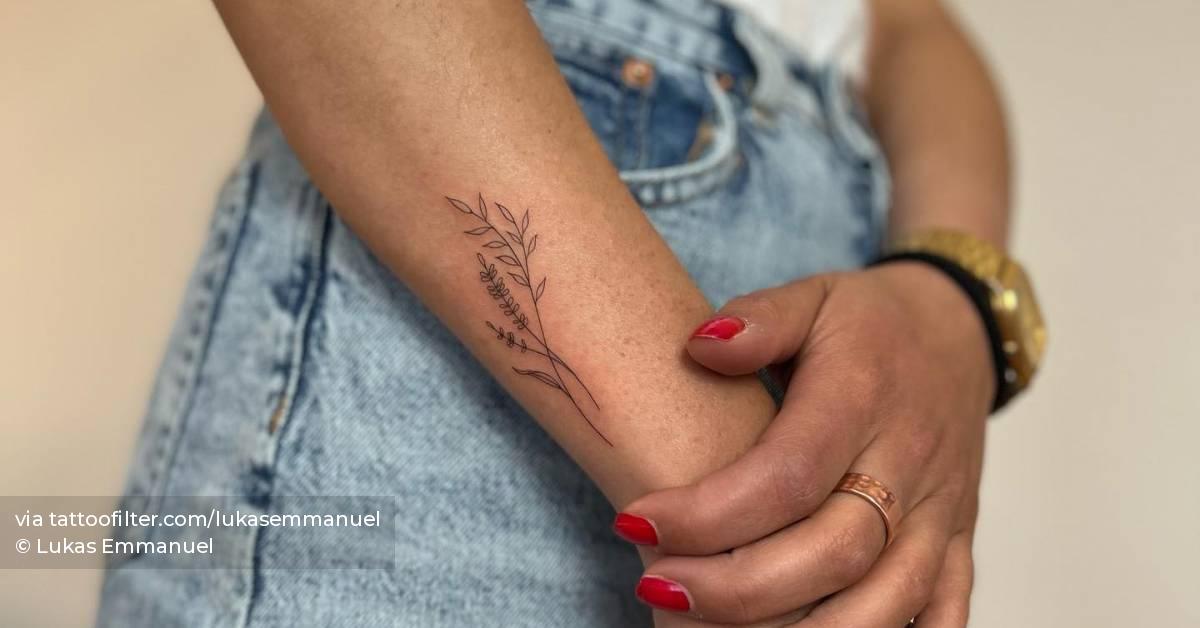 Fine line lavender tattoo located on the wrist.