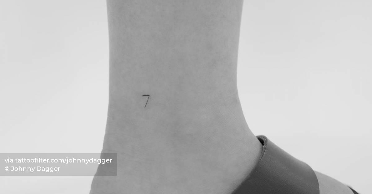 Tiny tattoo of the number "7" placed on the ankle.