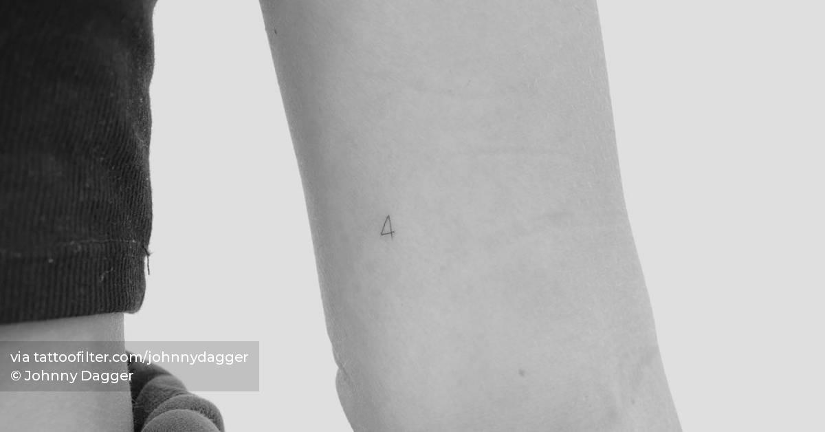 Number "4" tattooed on the inner arm.