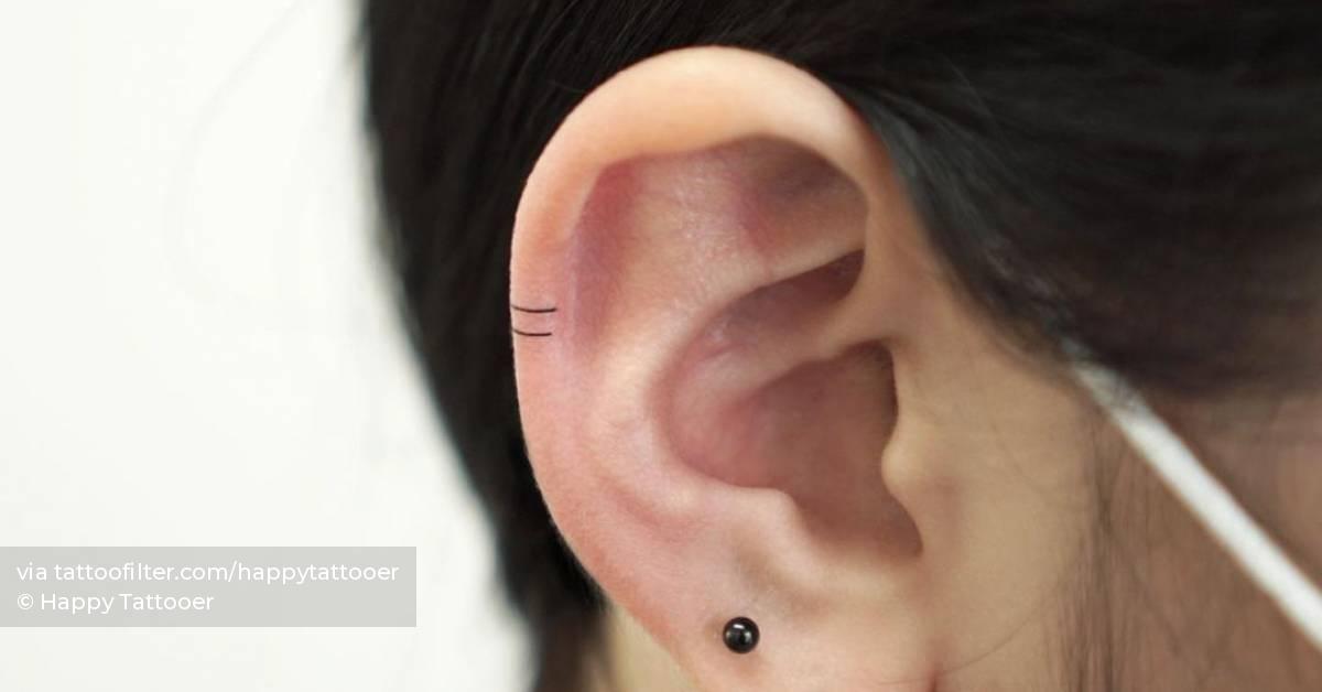 Tiny minimalistic lines tattooed on the ear helix.