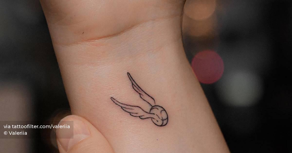 Minimalistic golden snitch tattoo done on the wrist.