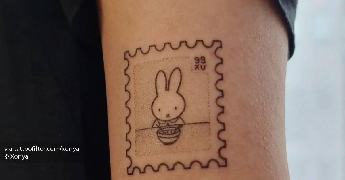 Miffy stamp tattoo hand poked on the tricep.