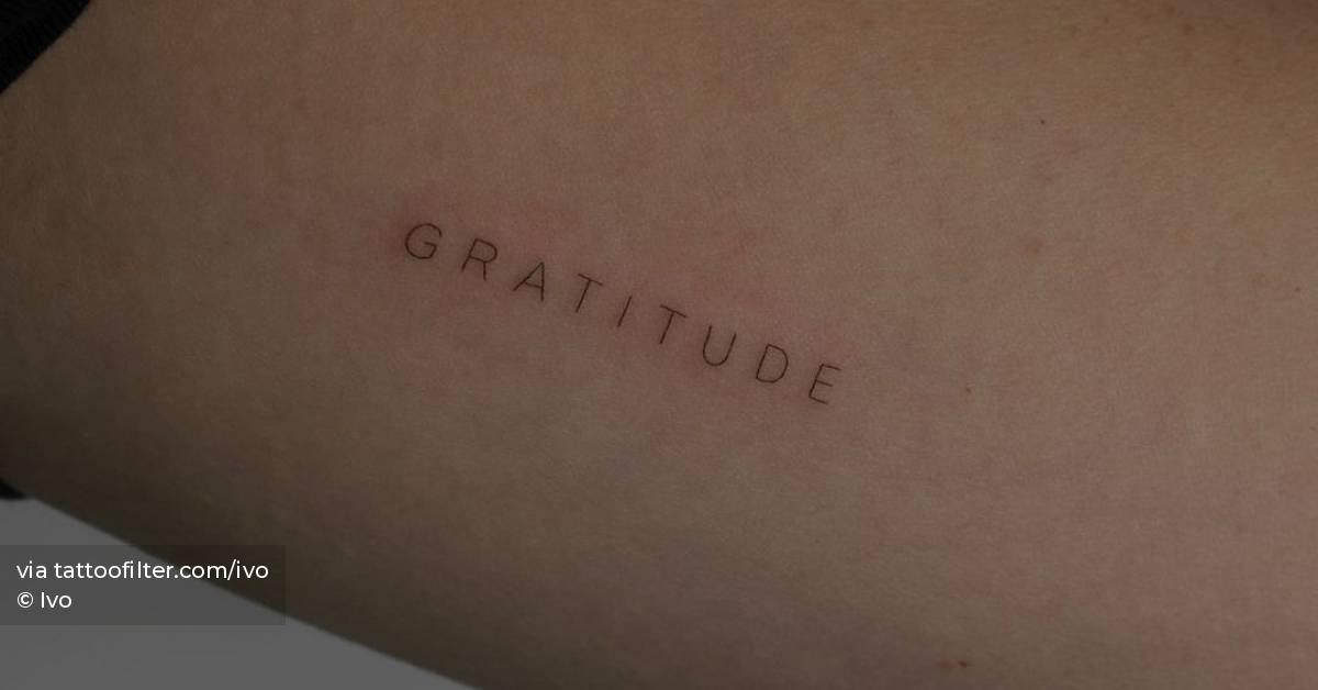 Tattoo of the word "gratitude" located on the inner