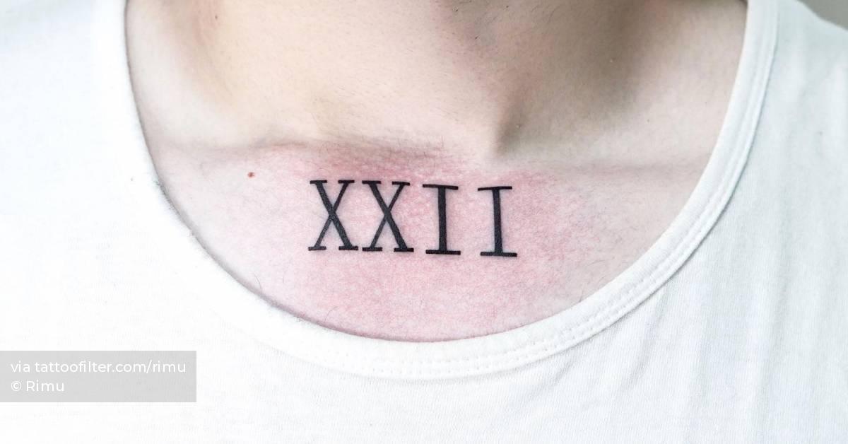 Roman numeral tattoo located on the collarbone.