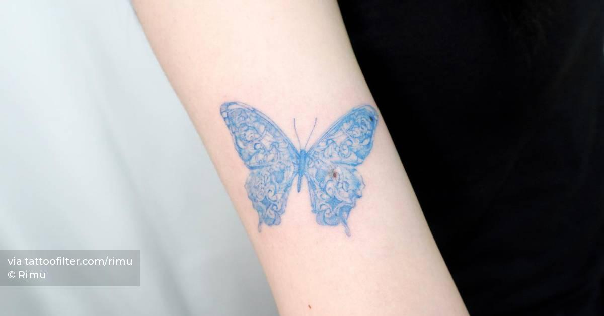 Blue butterfly tattoo placed on the bicep.