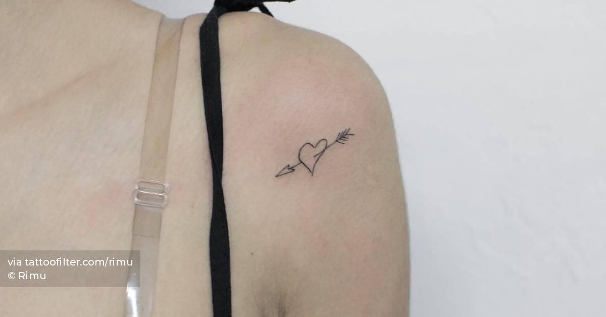 Minimalistic heart and arrow tattoo placed on the