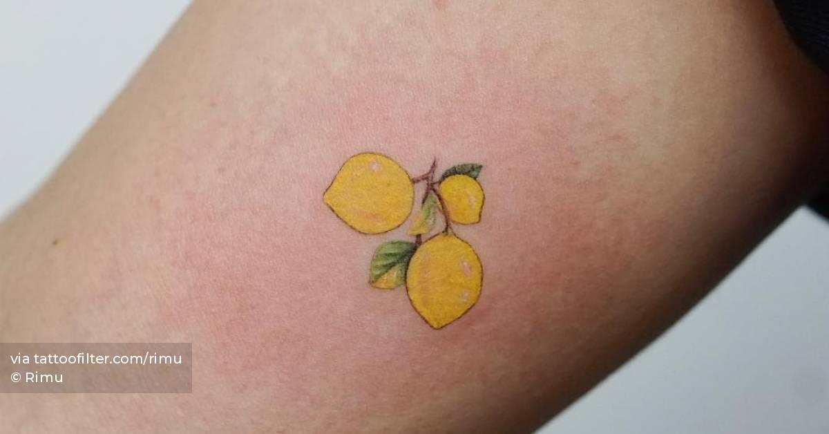 Micro-realistic style lemons tattooed on the inner arm.