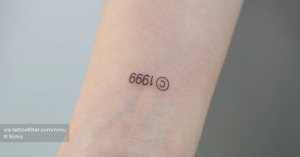 Copyright symbol and "1999" tattooed on the wrist.