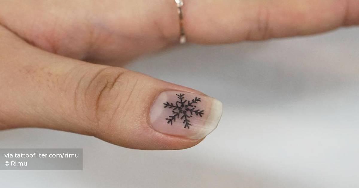 Minimalistic style snowflake tattoo located on the