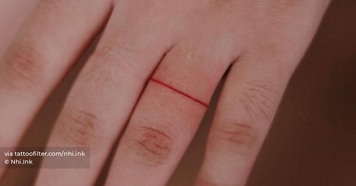 Minimalistic red ring tattooed on the finger.
