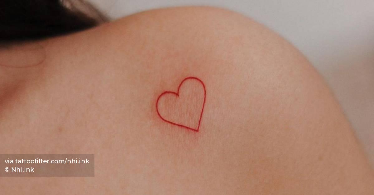 Minimalistic style red heart tattoo done on the