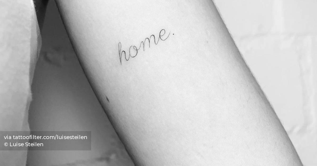 "Home" lettering tattoo on the inner arm.