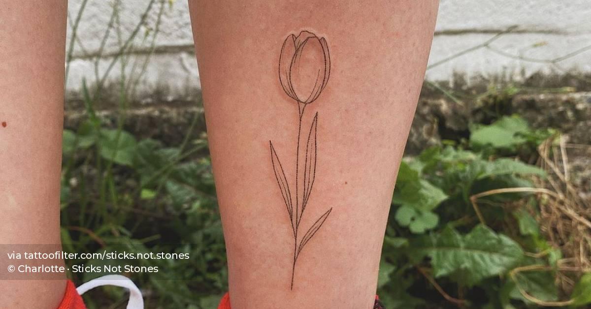 Fine line tulip tattoo on the achilles.