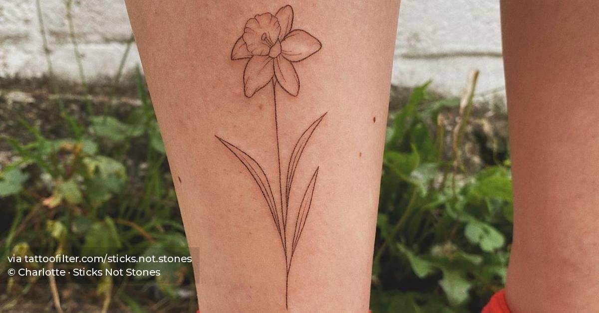 Fine line daffodil flower tattoo on the achilles.
